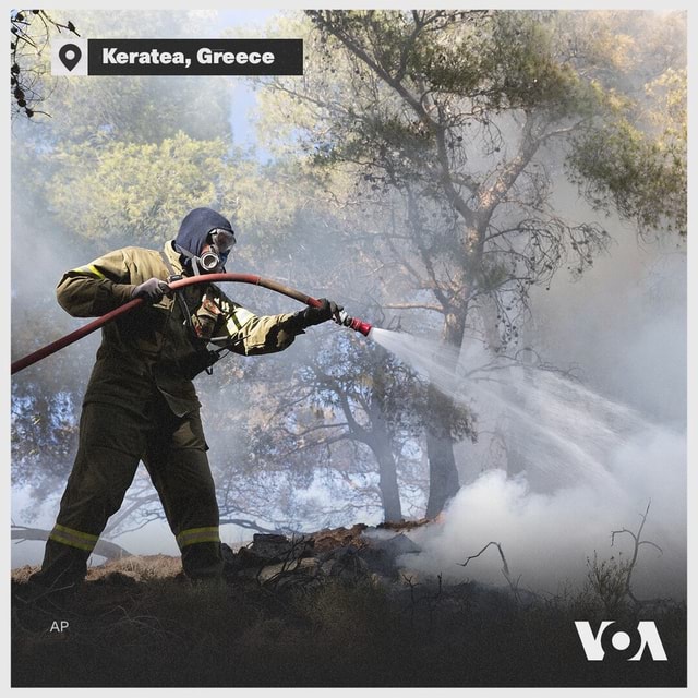 A firefighting helicopter and volunteers trying to extinguish a ...