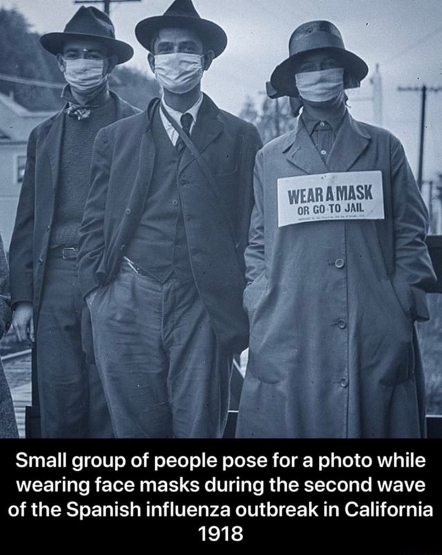 Small group of people pose for a photo while wearing face masks during ...