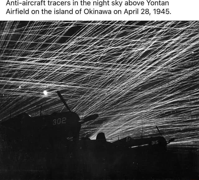 Antl-alrcrant Wacers the night sky above Yontan Airfield on the island ...