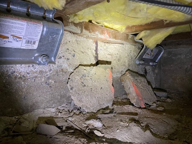 Here's a concrete foundation with some serious spall damage on the ...