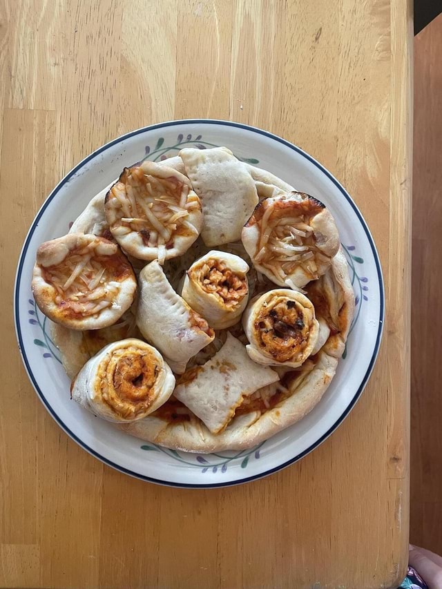 Pizza topped with deep dish muffins, minni calzones, and pizza spirals ...