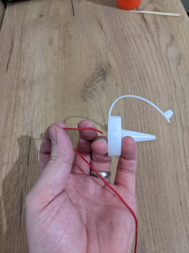 Try to fit the yarn through the conical nozzle from the ketchup bottle ...