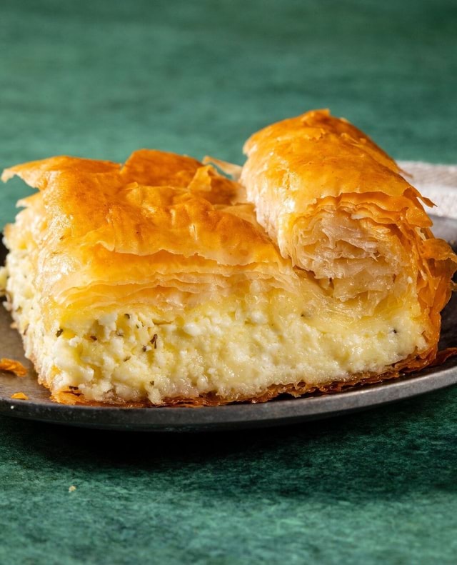 This savory Greek cheese pie is made with layers of butterbrushed ...