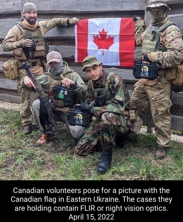 Canadian volunteers pose for a picture with the Canadian flag in ...