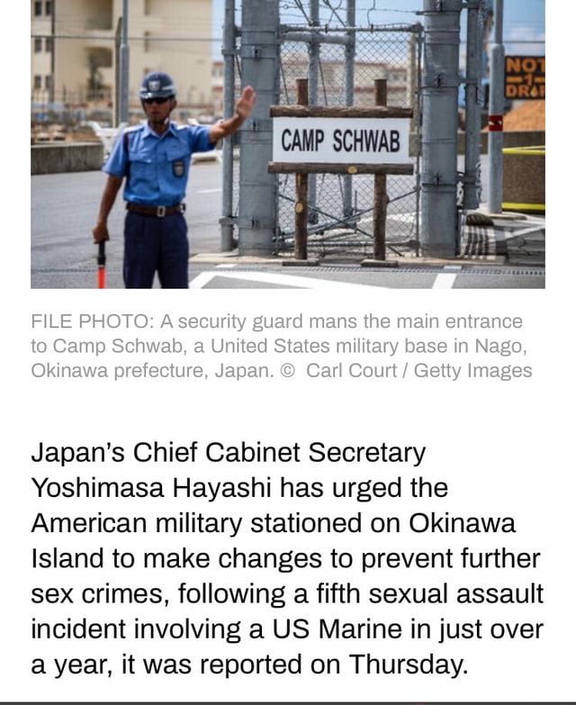 FILE PHOTO: A security guard mans the main entrance to Camp Schwab, a ...