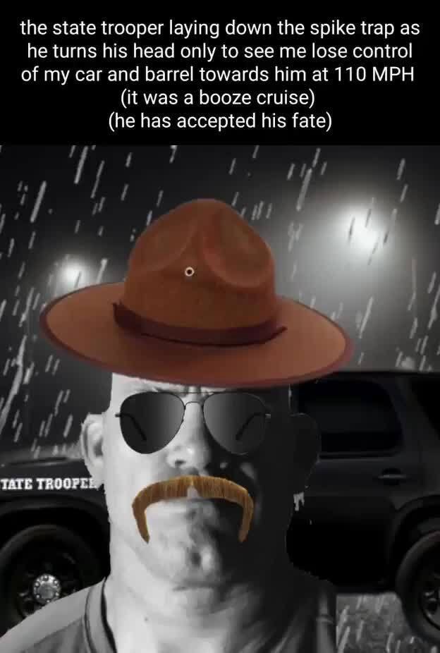 The state trooper laying down the spike trap as he turns his head only ...