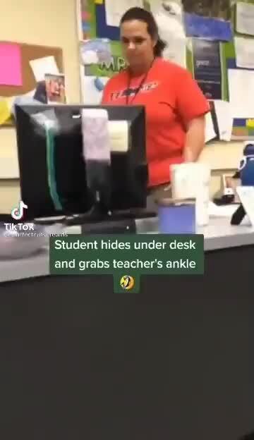 Student hides under desk and grabs teacher's ankle - iFunny